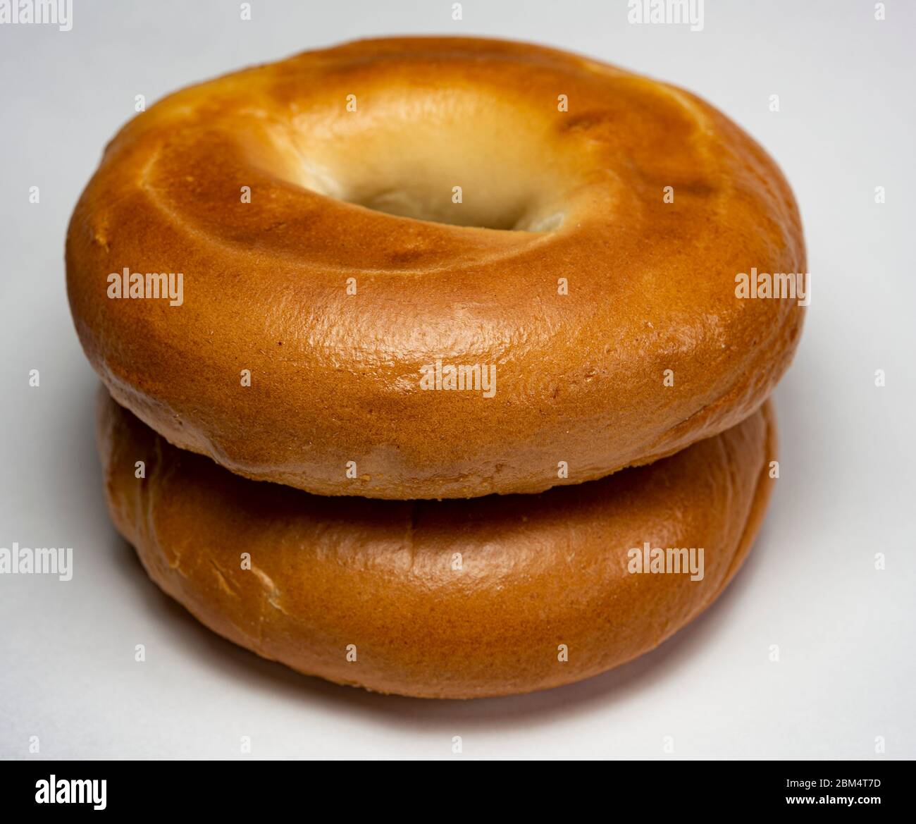 Two bagels on a white background Stock Photo - Alamy