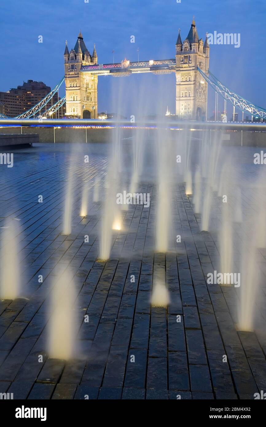 Tower Bridge and a fountain at dusk Stock Photo - Alamy