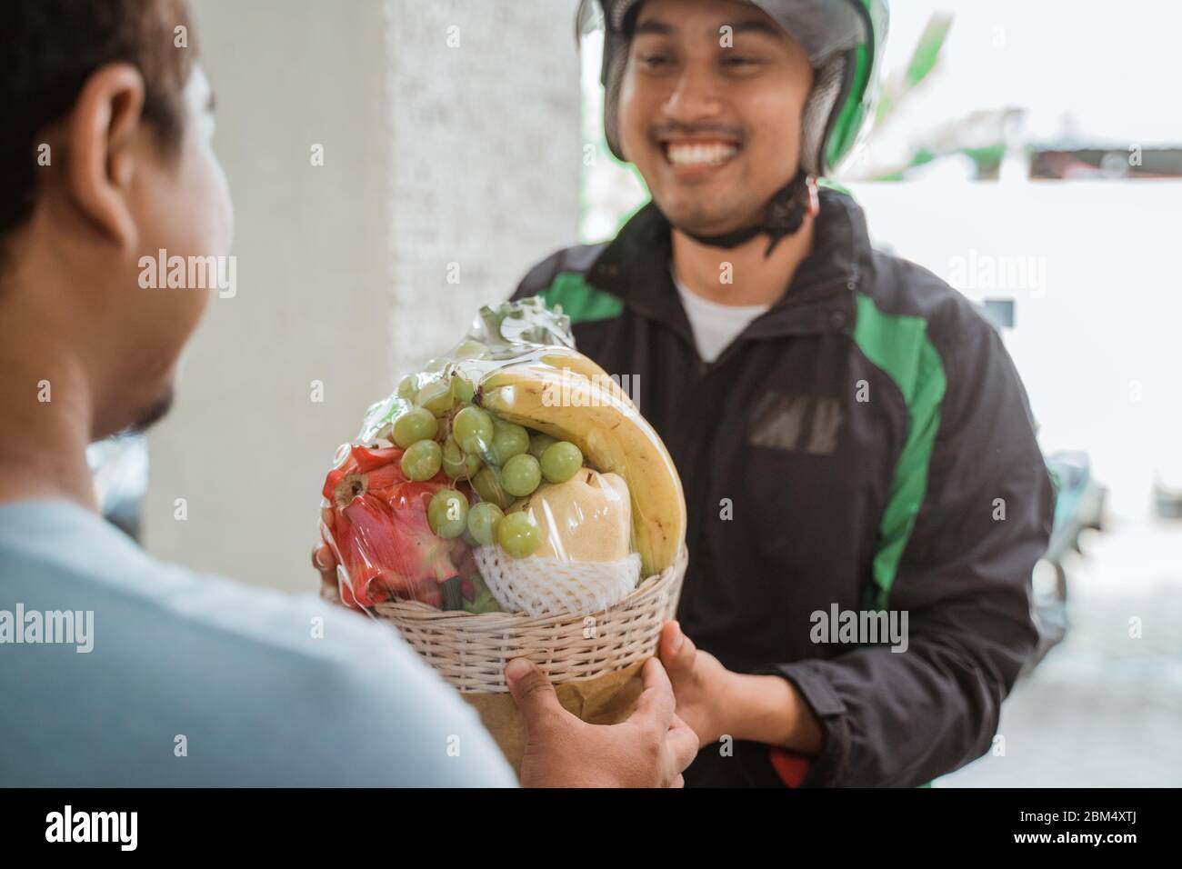 portrait of asian delivery man delivering fruit parcel Stock Photo - Alamy