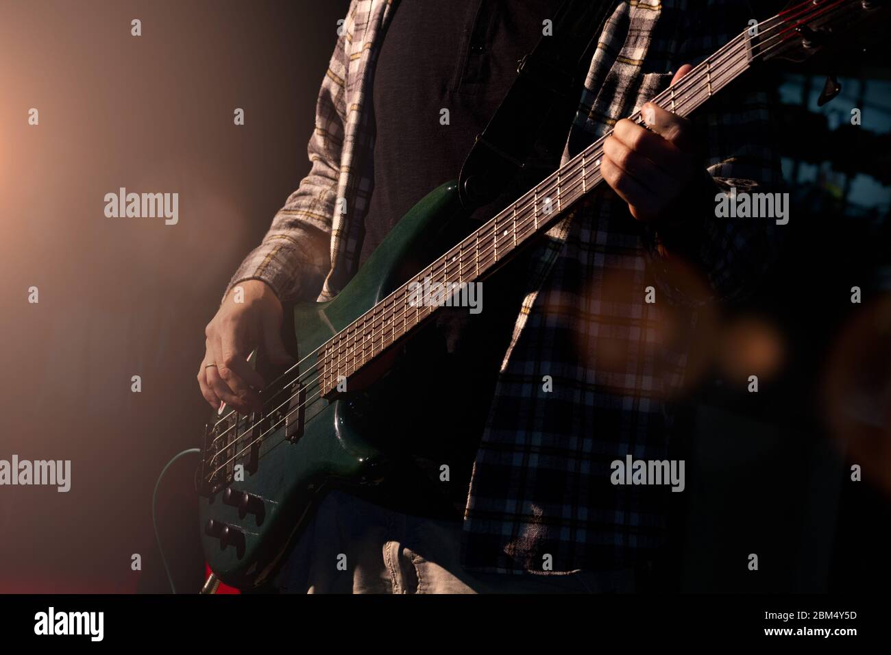Electric bass guitar player, closeup photo with soft selective focus on ...
