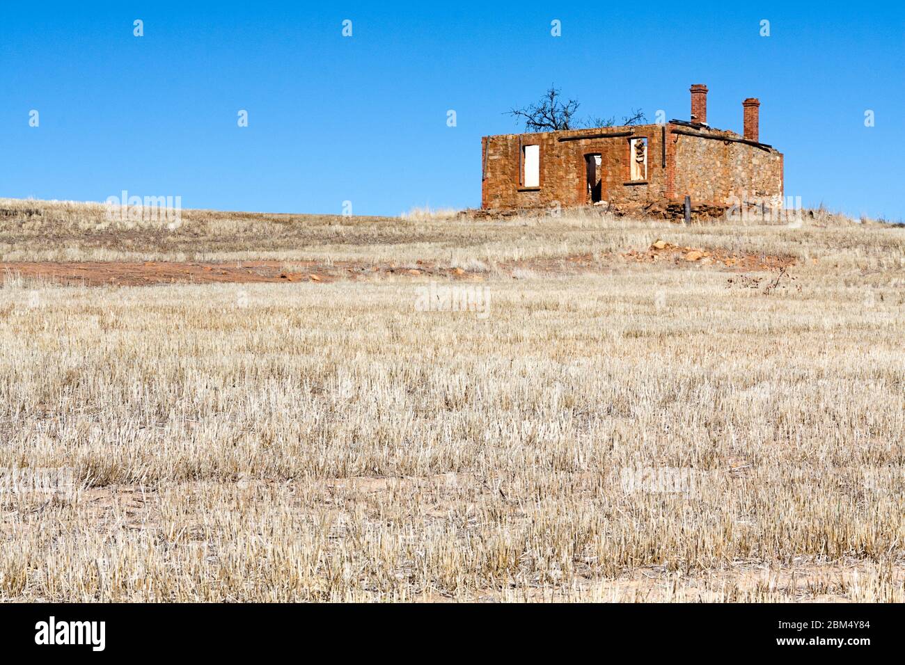 An old ruin of a barn on top of a hill after harvest in the Australian ...