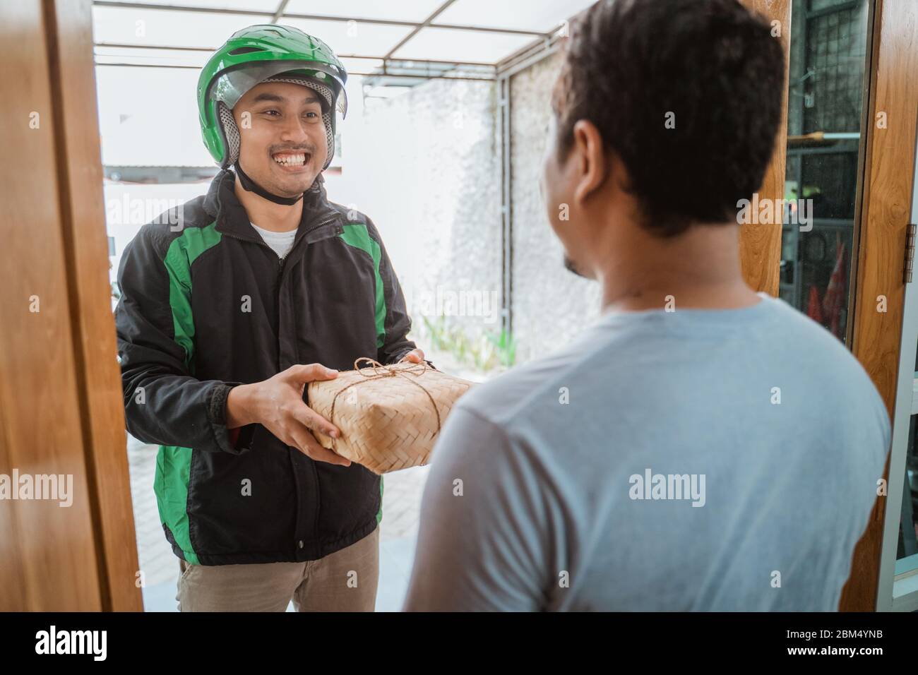 man ordering food online and receive the order at home delivered by ...