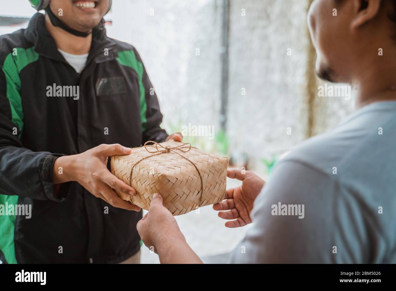 Delivery man delivering food to a man at home - online food shopping ...