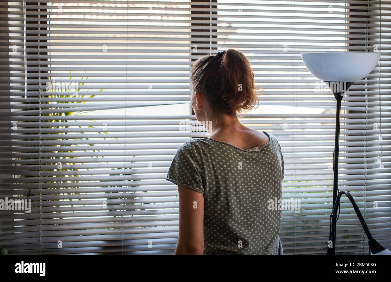 Sad girl looking out window white hi-res stock photography and images ...