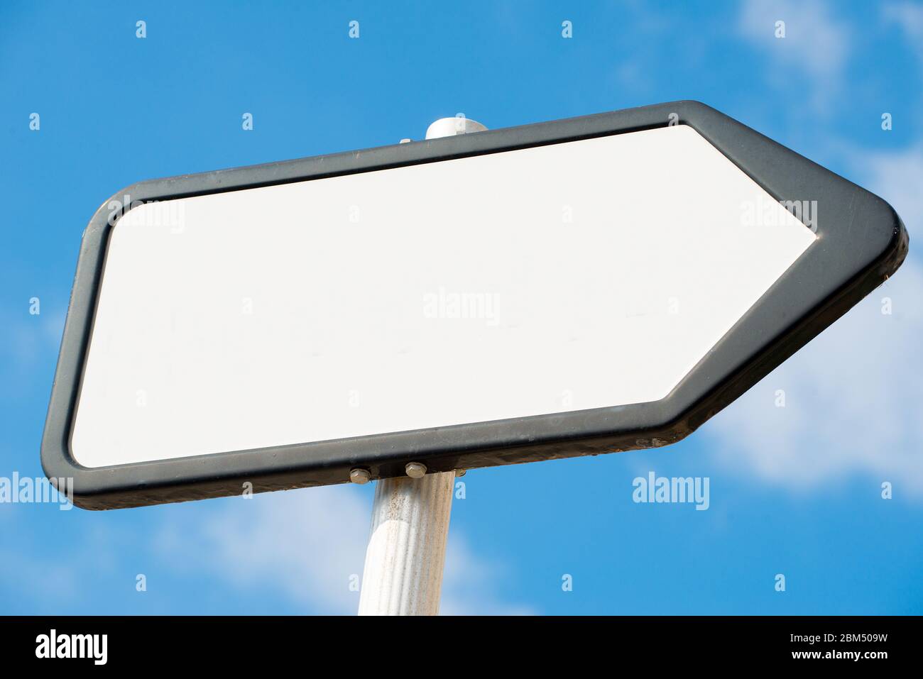 Low angle view of a plain white, blank, pointing the way, information ...