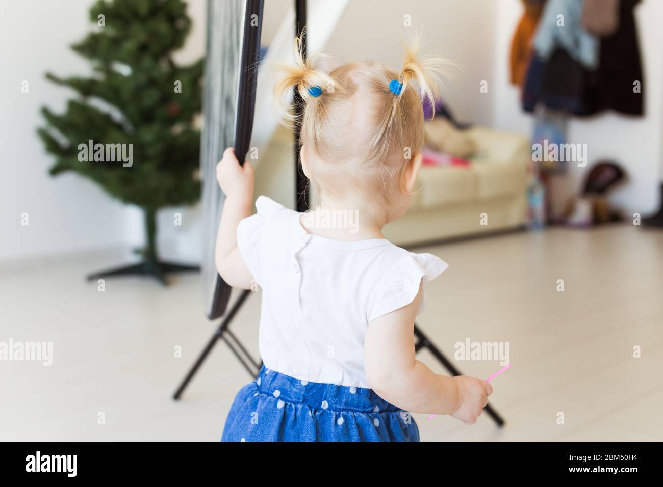 Cute baby girl playing indoors. Childhood, infant and children concept ...