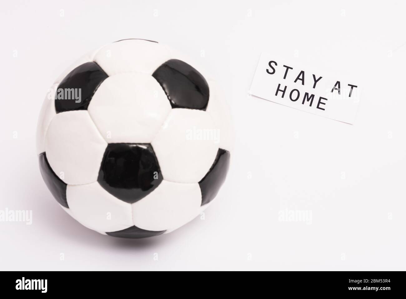 football near paper with stay at home lettering on white with copy ...