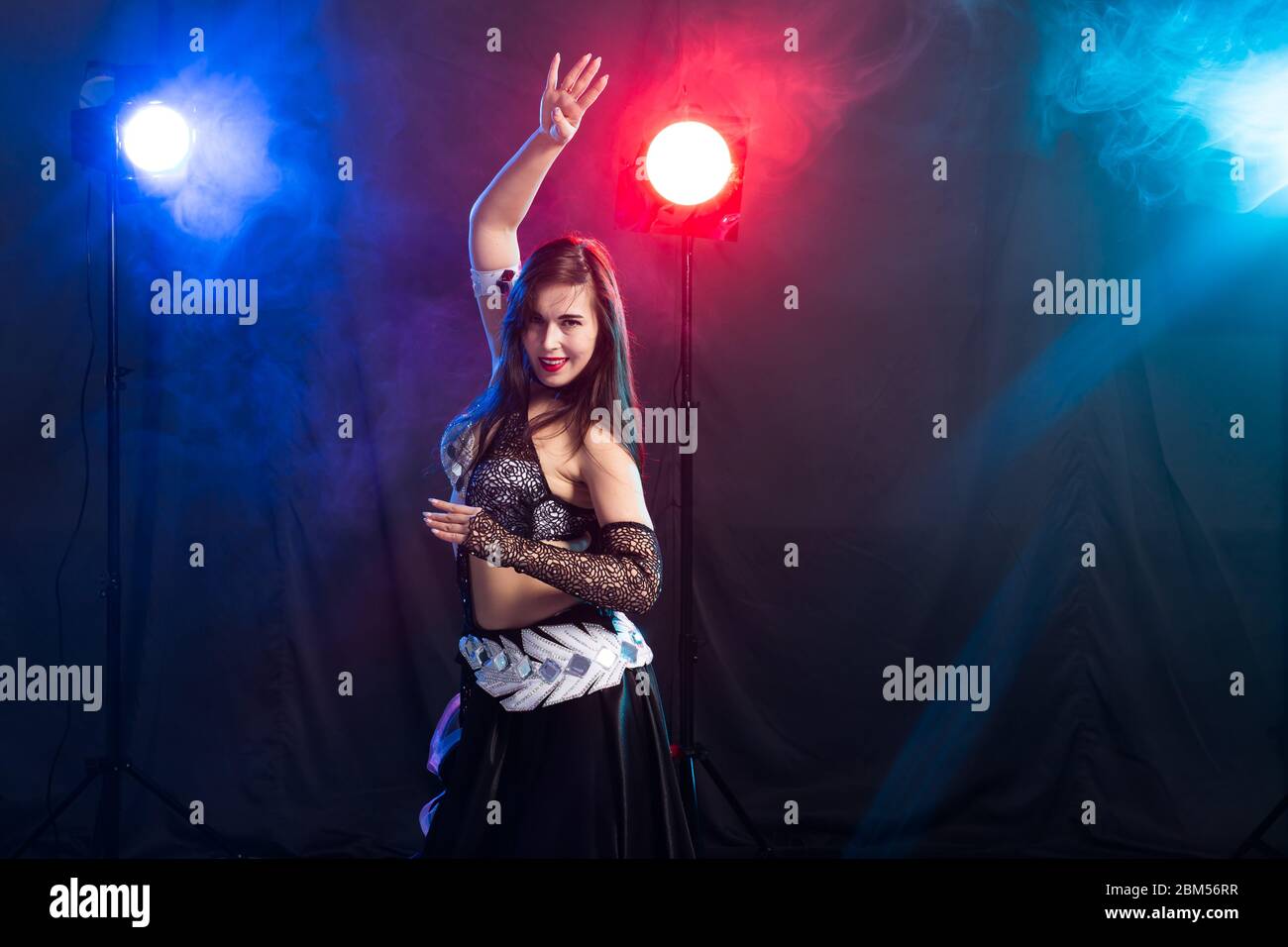 Young woman belly dancer in exotic dress with gold, dancing tribal ...