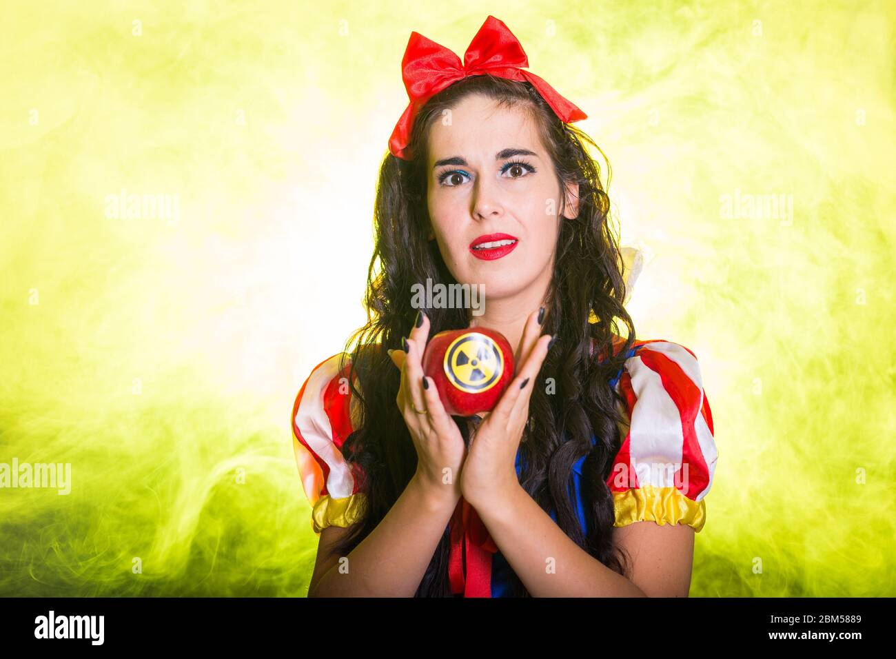 Woman holding hazardous radioactive apple. Nuclear and radiation ...