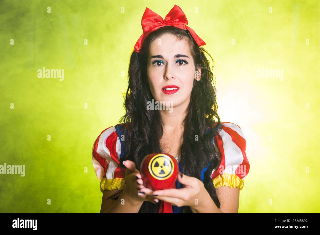 Woman holding hazardous radioactive apple. Nuclear and radiation ...