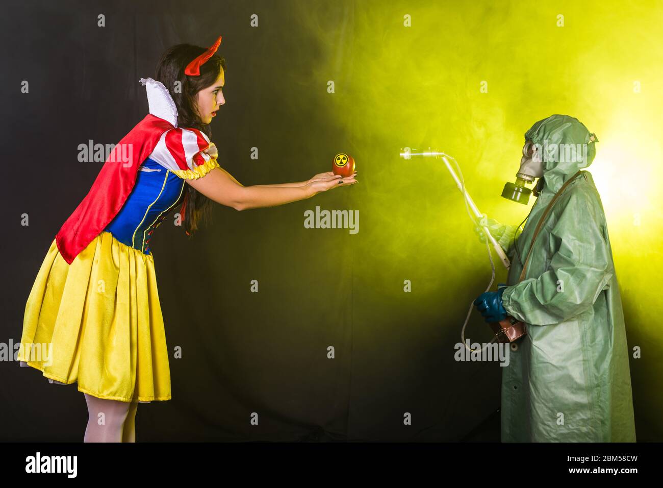 Woman holding hazardous radioactive apple. Nuclear and radiation ...