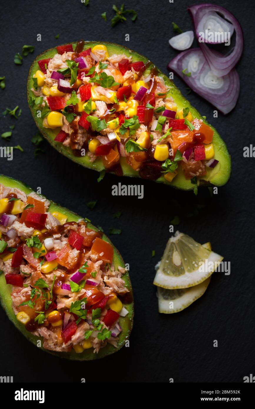 Avocado filled with tuna fish and vegetables Stock Photo - Alamy