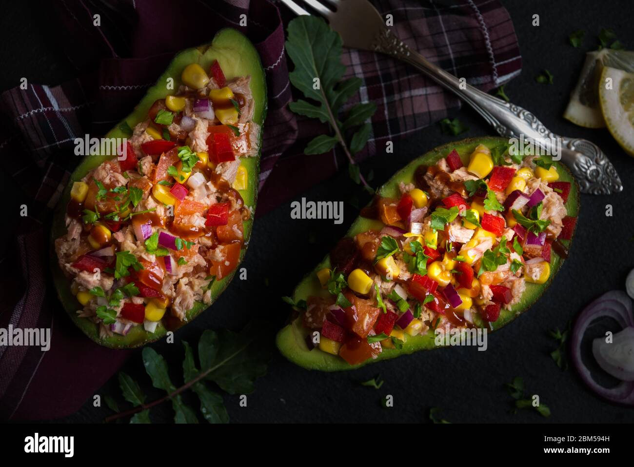 Avocado filled with tuna fish and vegetables Stock Photo - Alamy