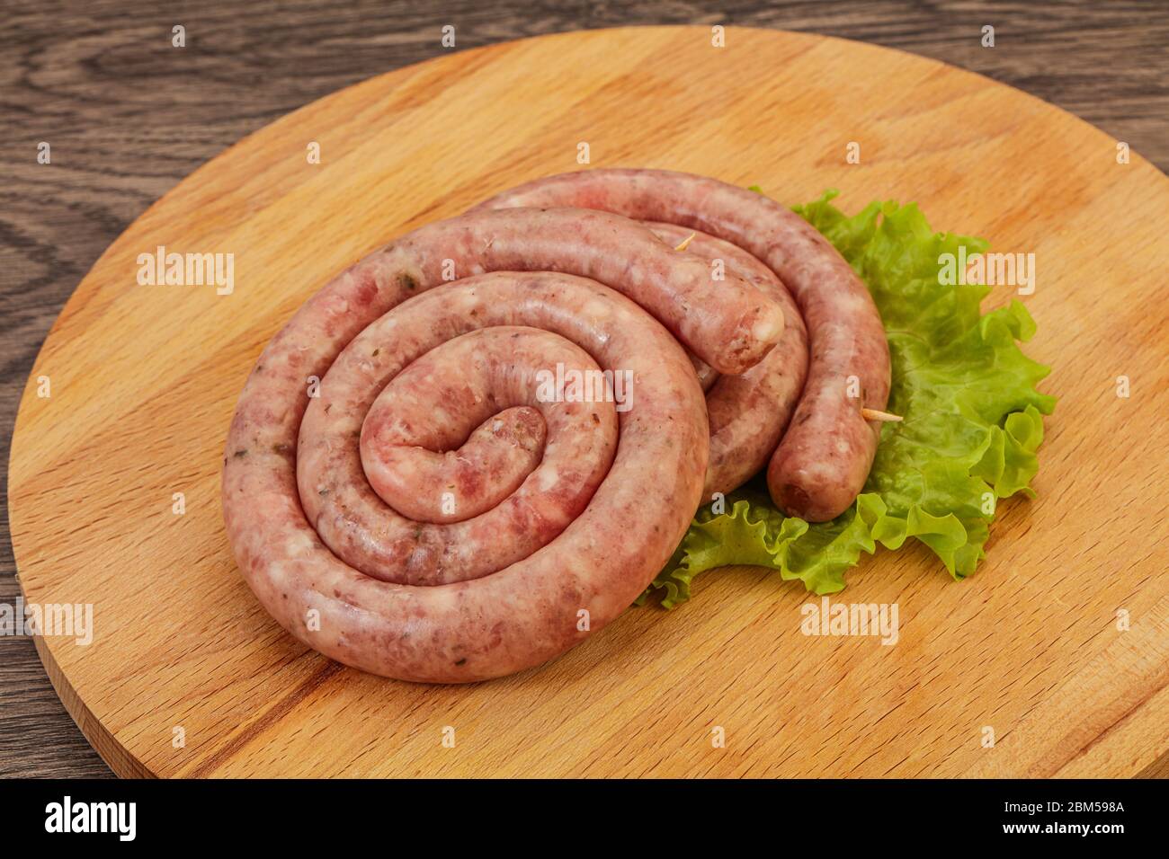 Raw pork sausage ring for grill Stock Photo - Alamy