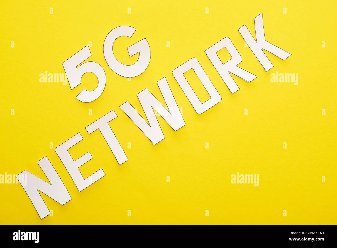 top view of white 5g network lettering on yellow background Stock Photo ...