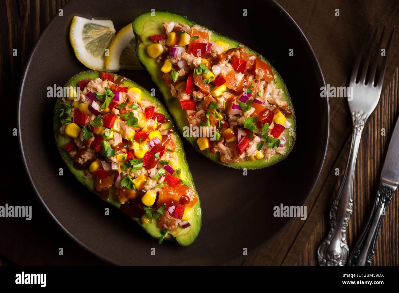 Avocado filled with tuna fish and vegetables Stock Photo - Alamy