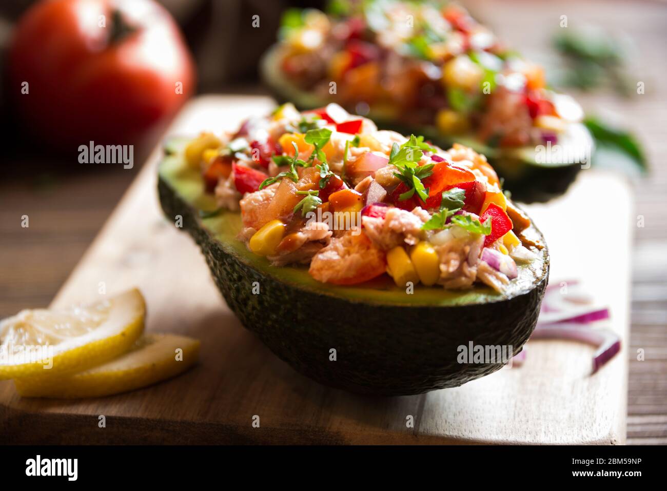 Avocado filled with tuna fish and vegetables Stock Photo - Alamy
