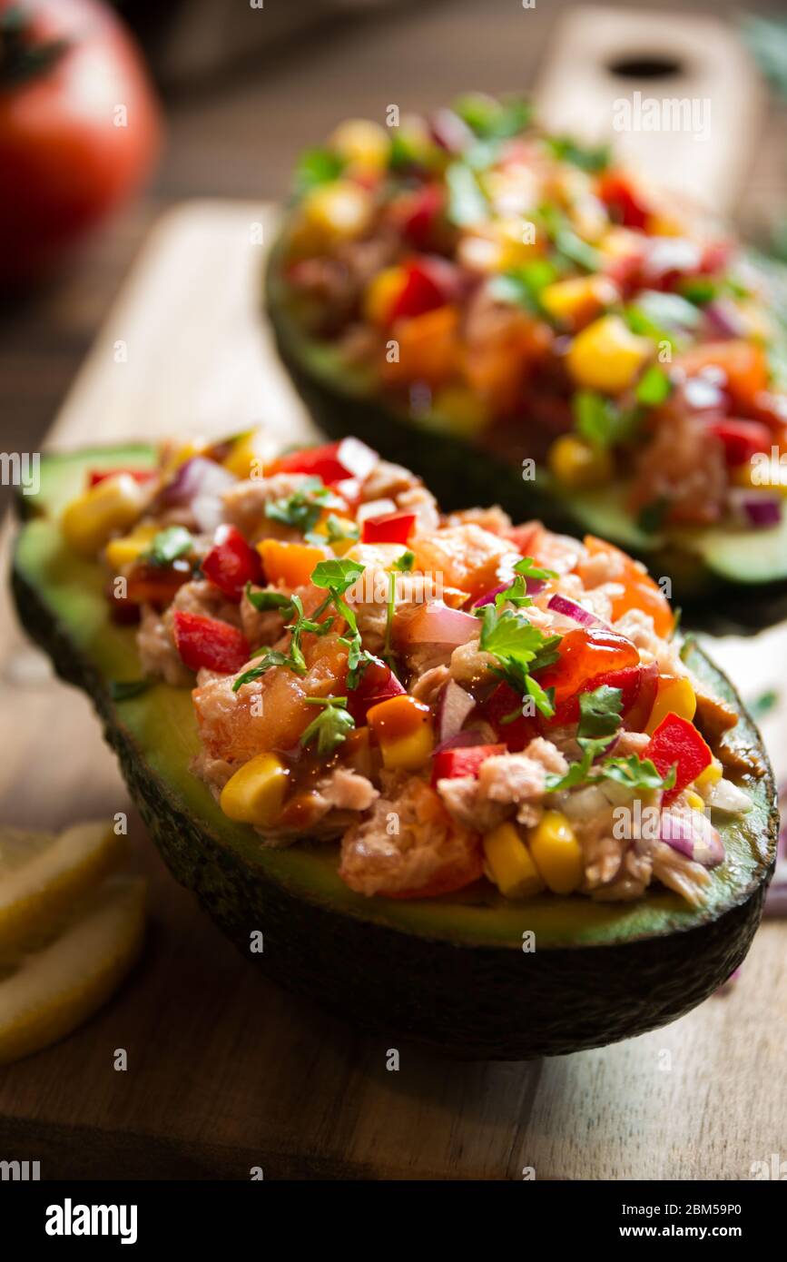 Avocado filled with tuna fish and vegetables Stock Photo - Alamy