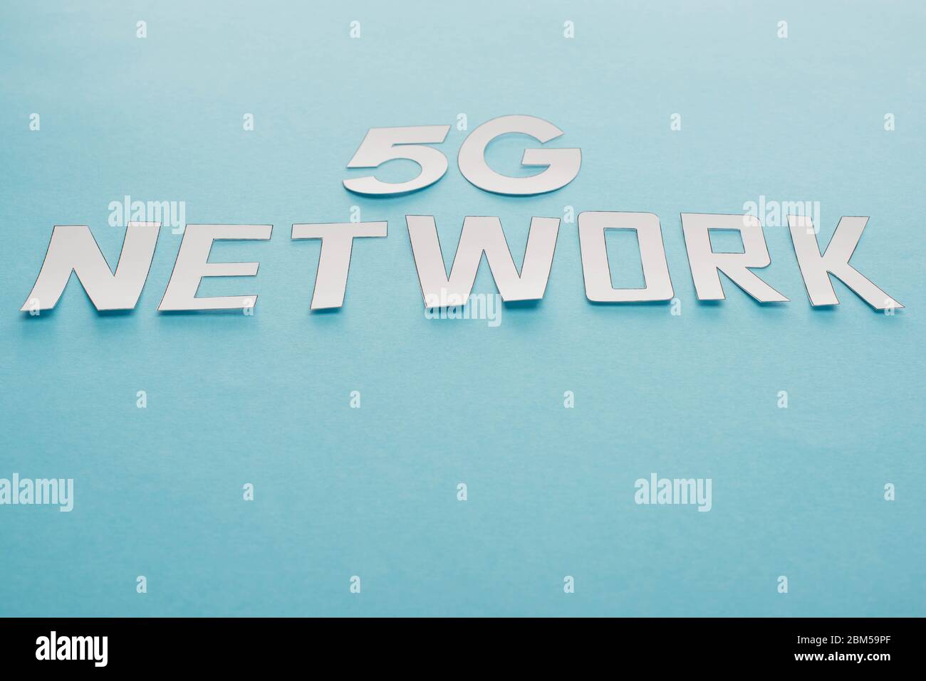 white 5g network lettering on blue background Stock Photo - Alamy