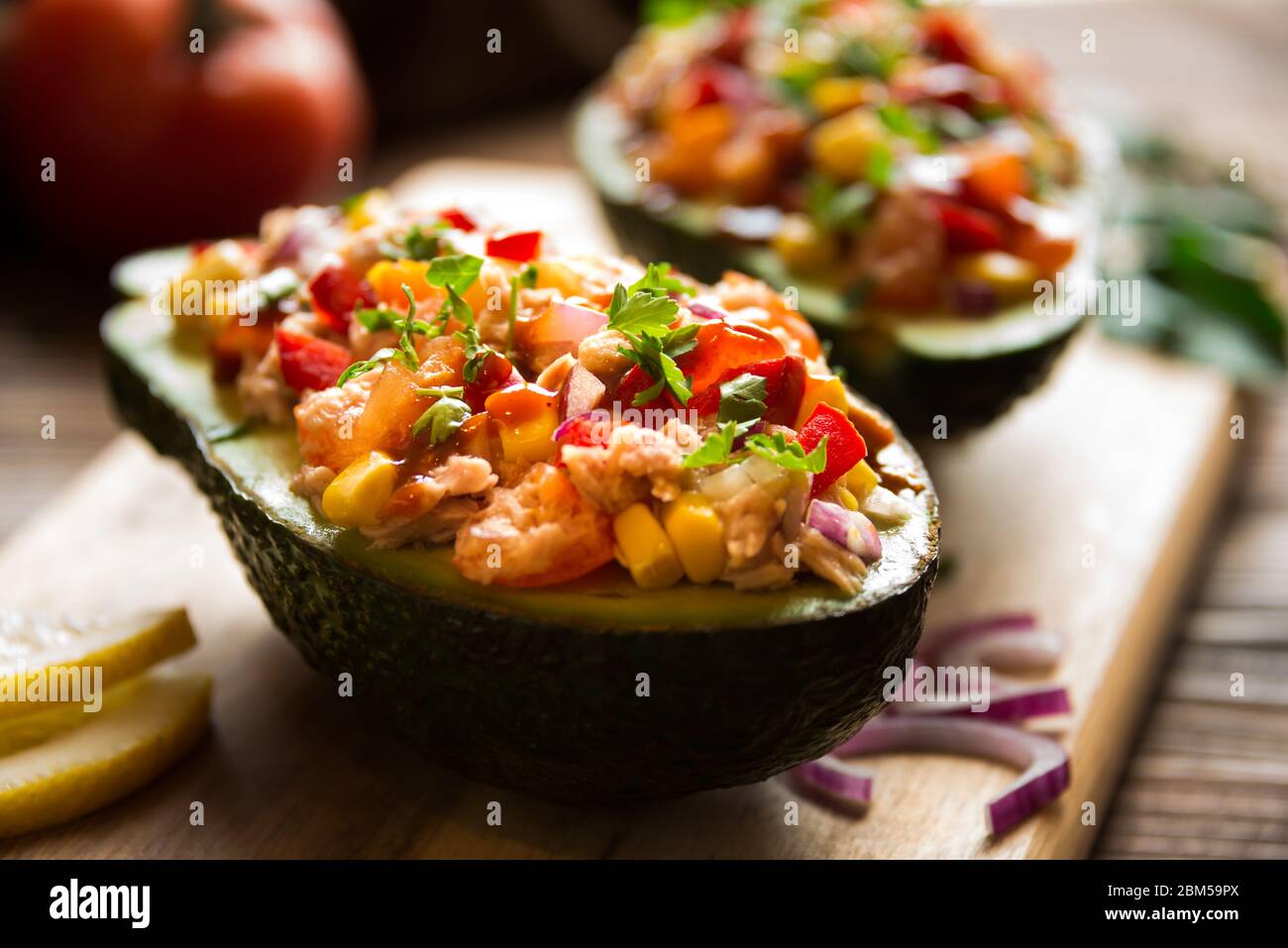 Avocado filled with tuna fish and vegetables Stock Photo - Alamy