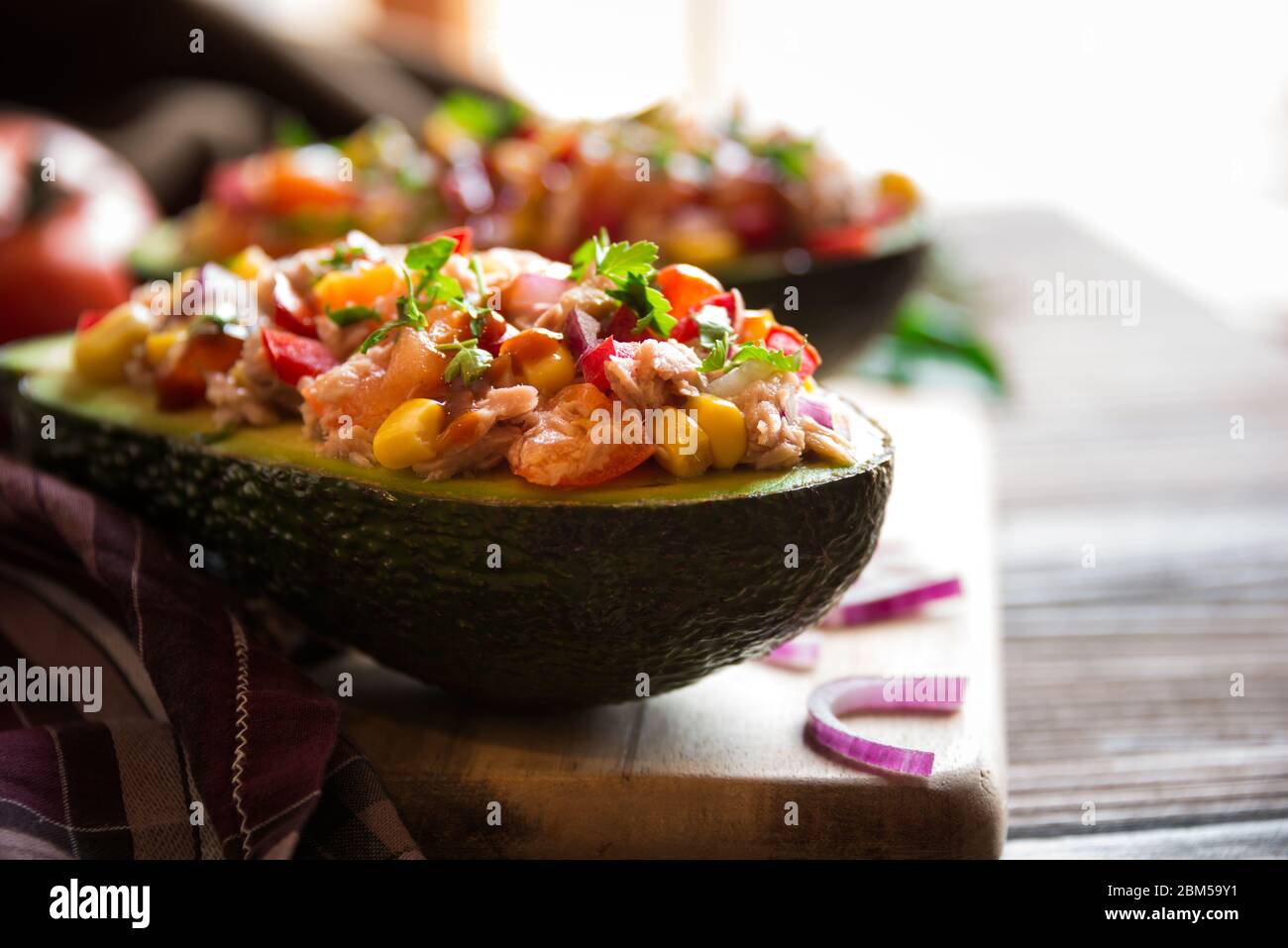 Avocado filled with tuna fish and vegetables Stock Photo - Alamy