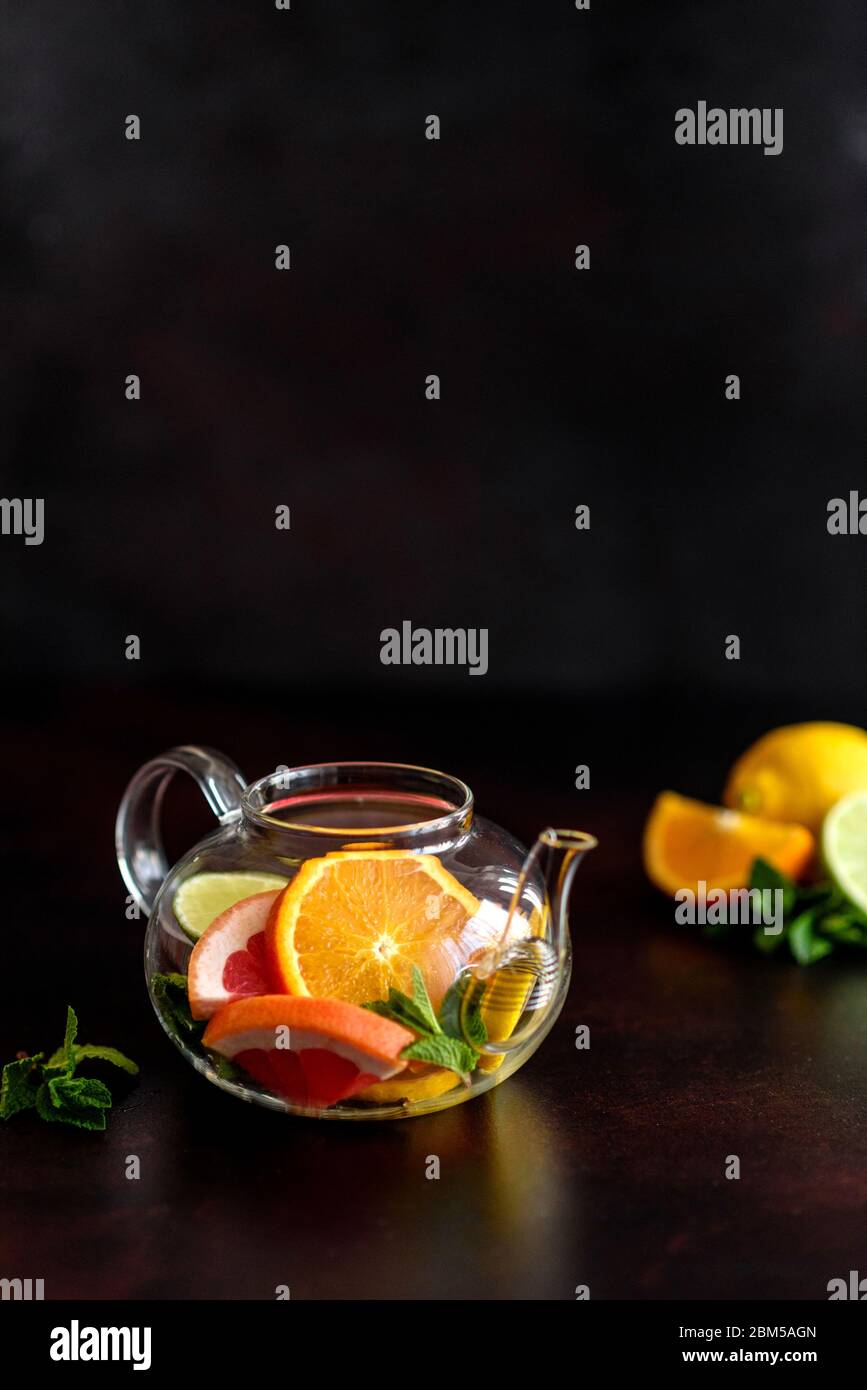 Hot fruit tea with lemon, mint, orange, lime and grapefruit in a ...
