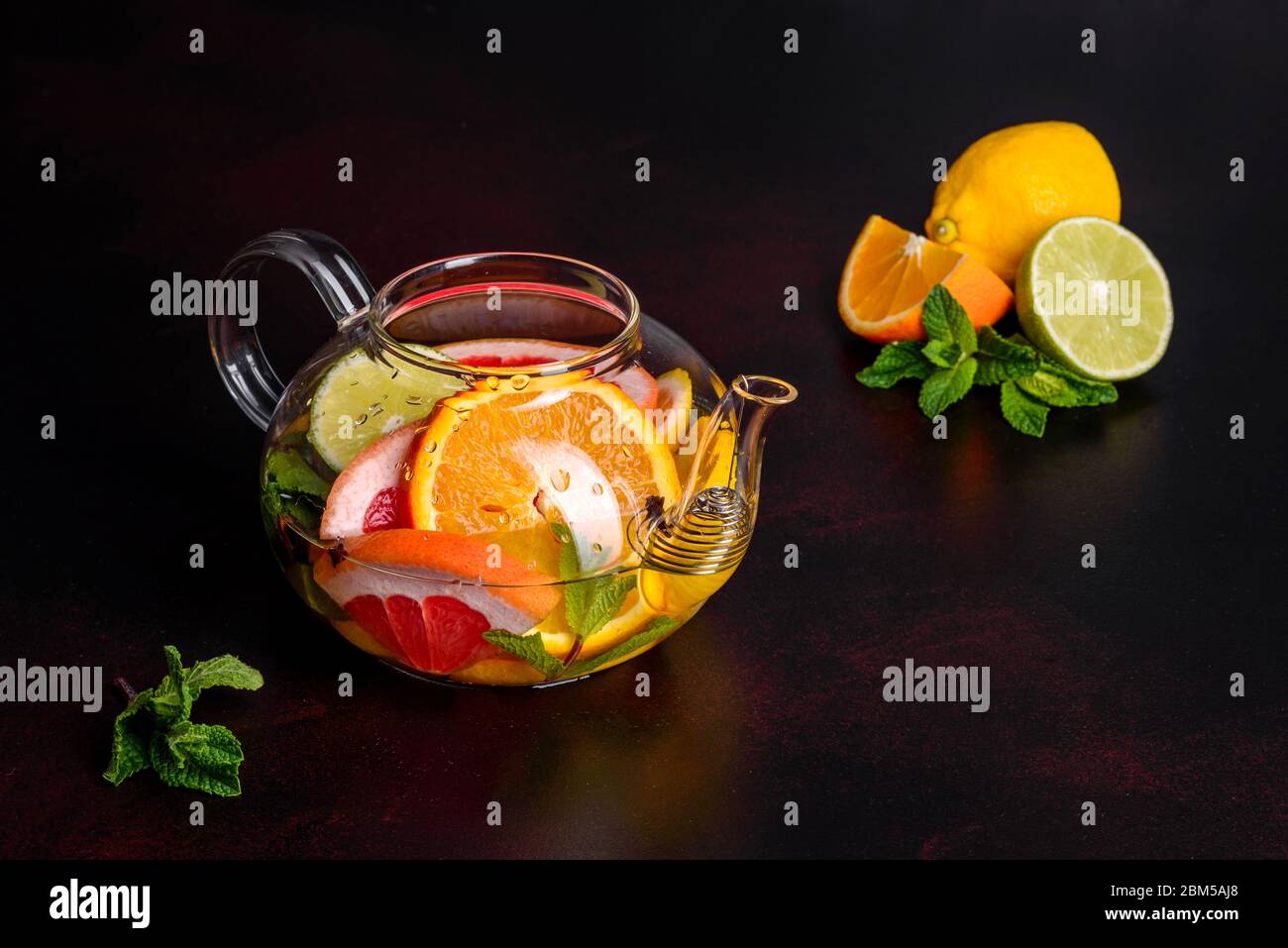 Hot fruit tea with lemon, mint, orange, lime and grapefruit in a ...