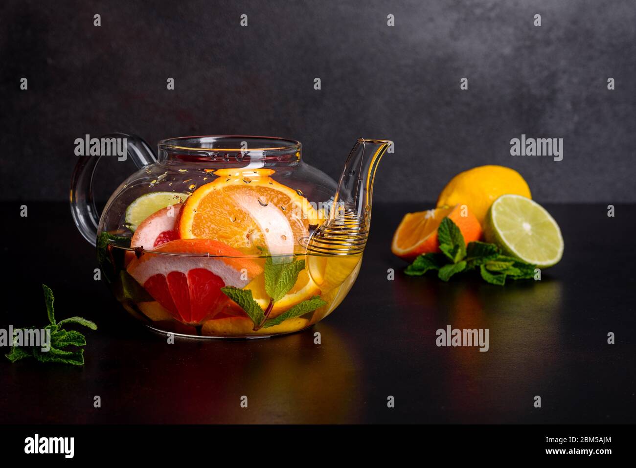 Hot fruit tea with lemon, mint, orange, lime and grapefruit in a ...