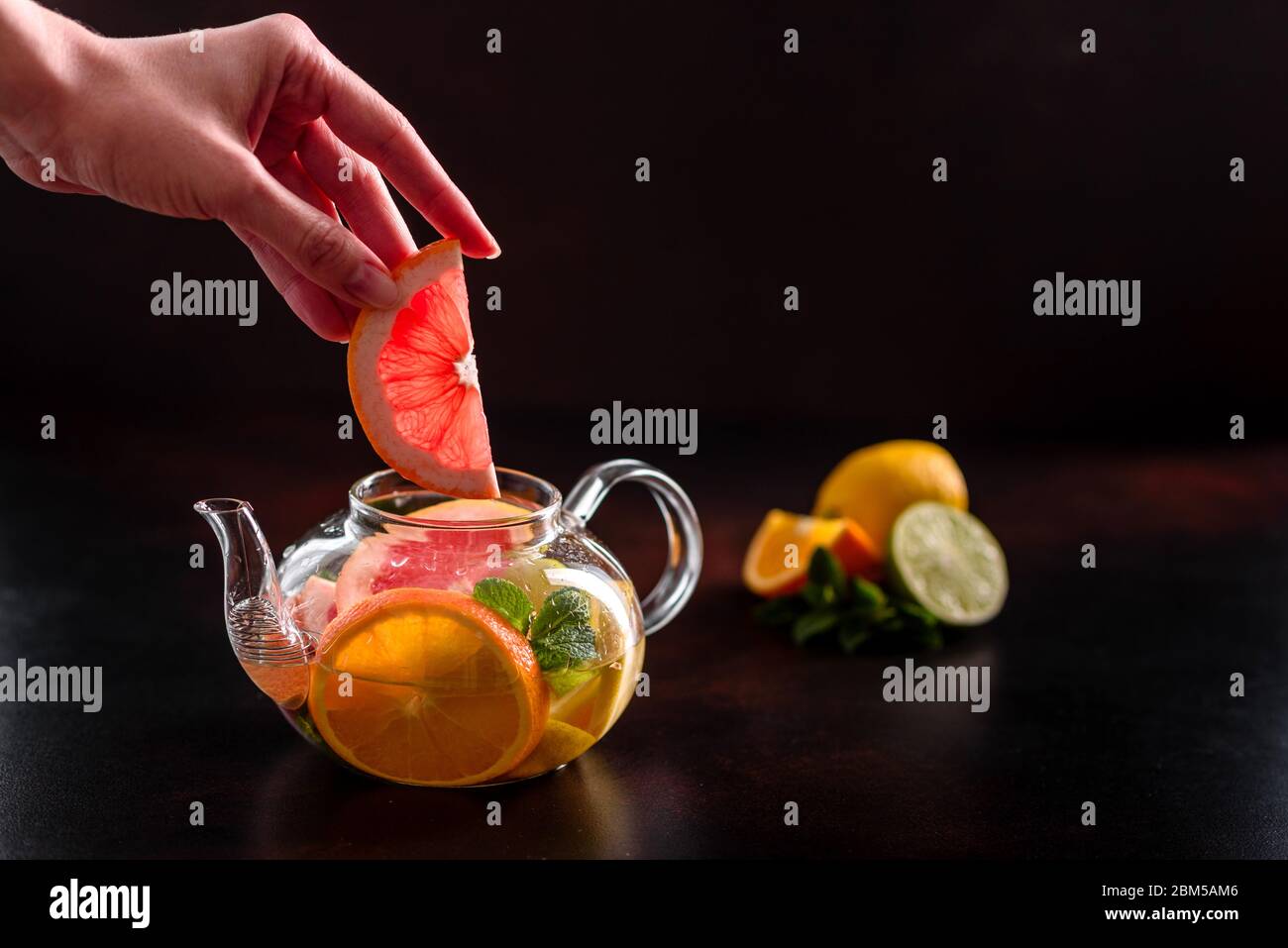 Hot fruit tea with lemon, mint, orange, lime and grapefruit in a ...