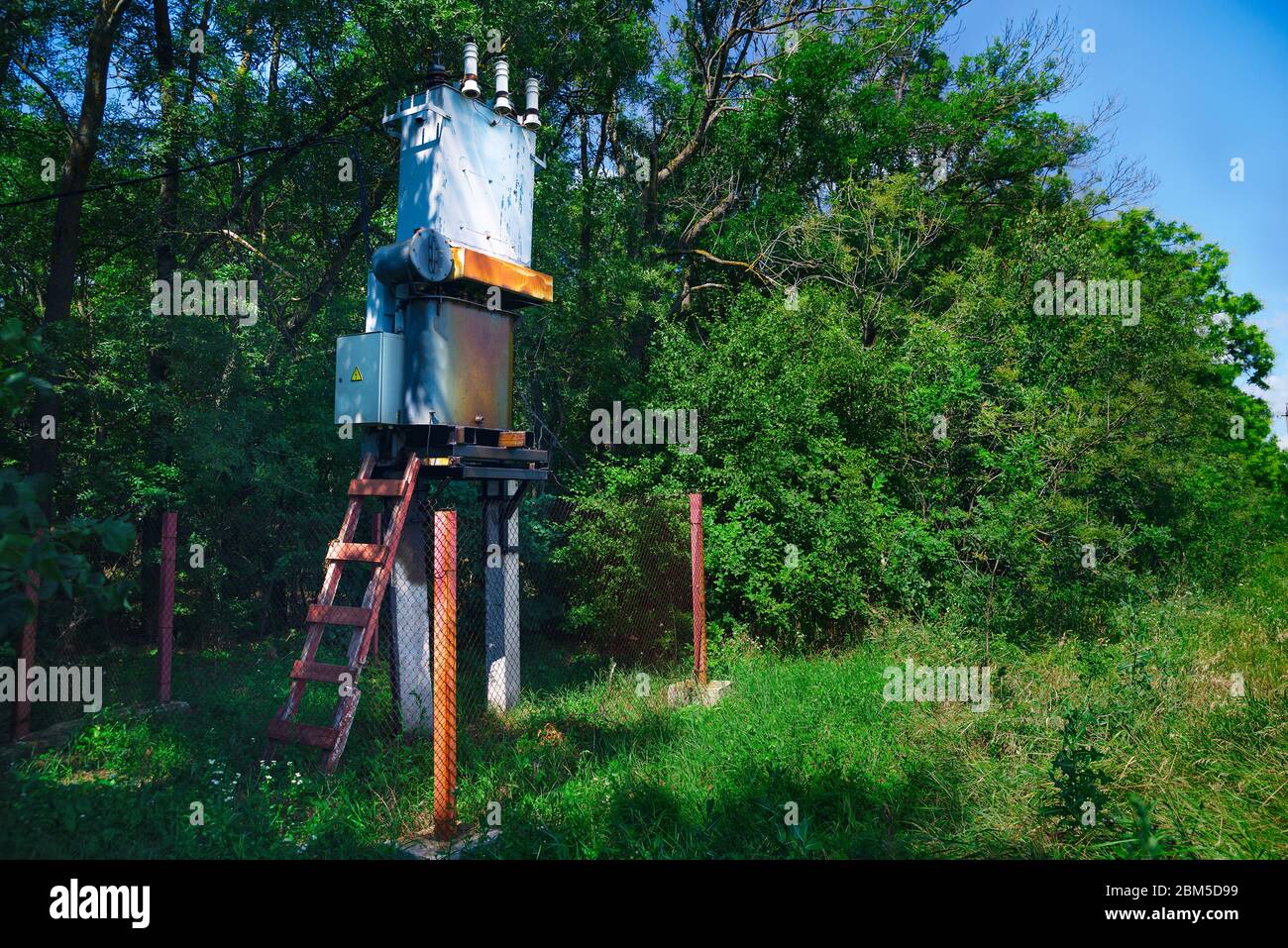 Old working rural electrical distribution transformer in the forest ...