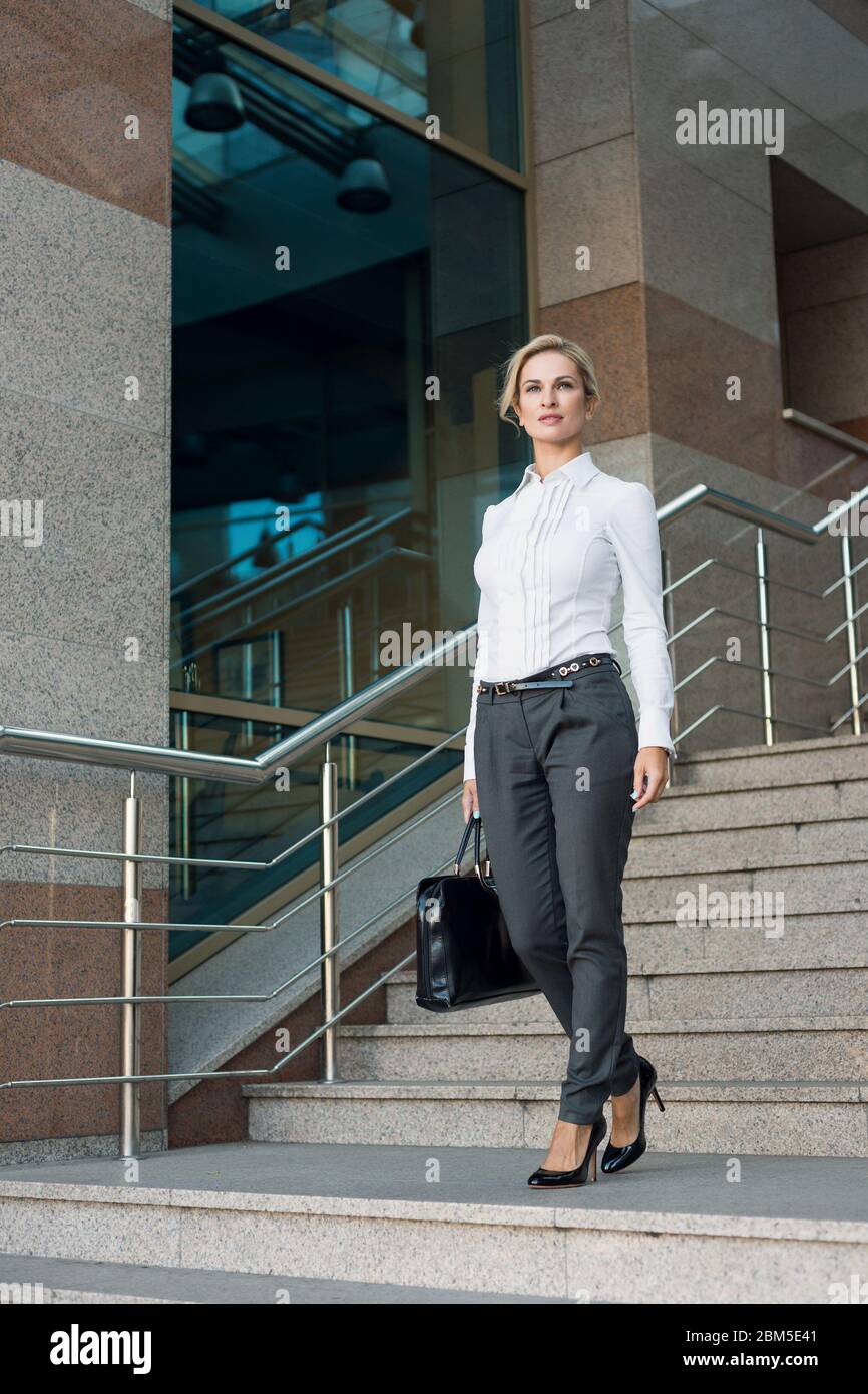 Beautiful business woman goes to work Stock Photo - Alamy