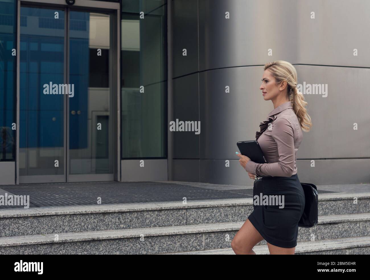 Beautiful business woman goes to work Stock Photo - Alamy