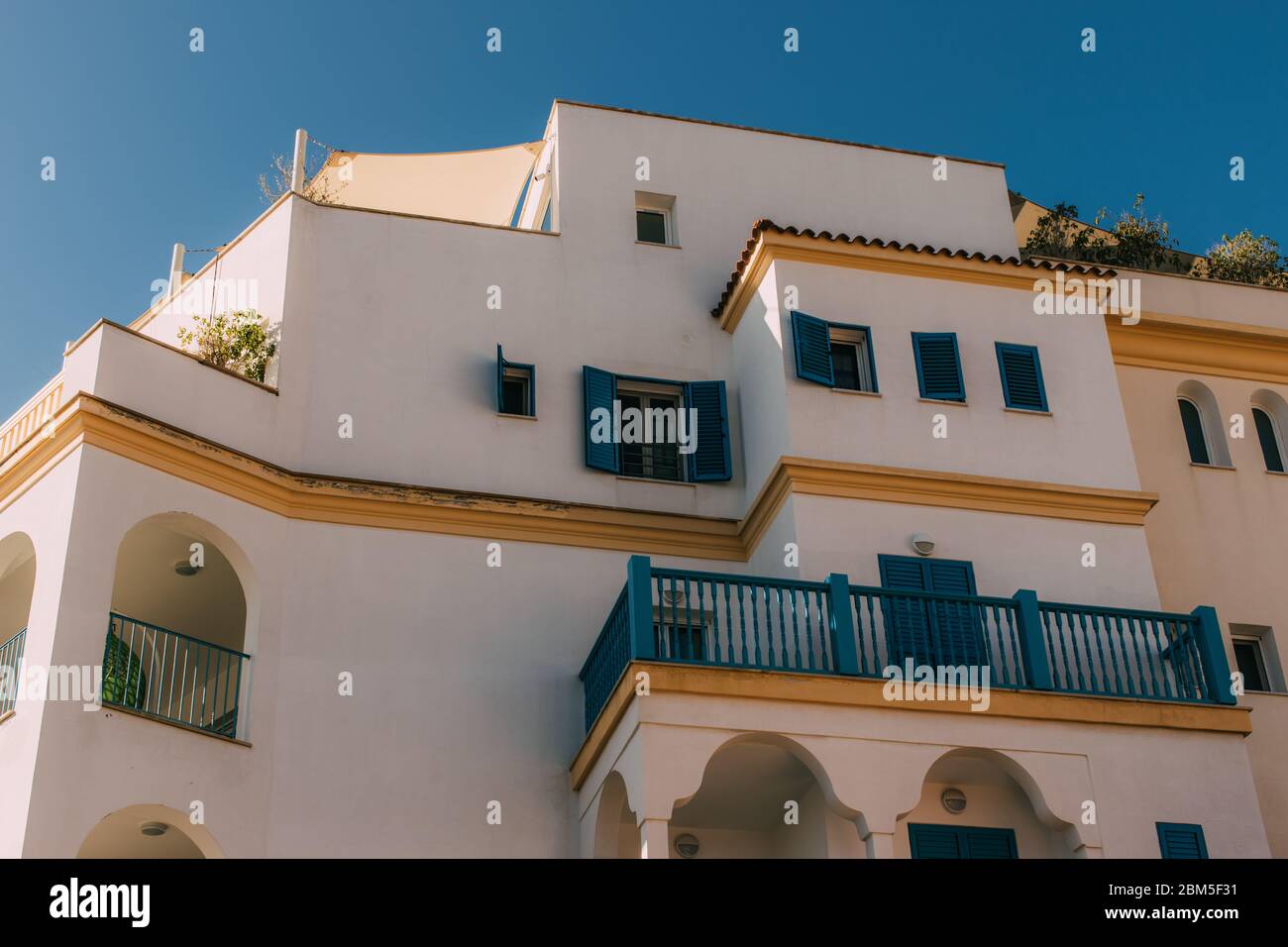 sunlight on modern building with blue balconies Stock Photo - Alamy