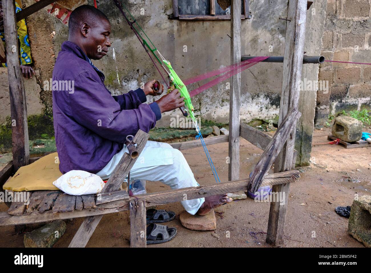 Man weaving with wool on a handmade loom Stock Photo - Alamy