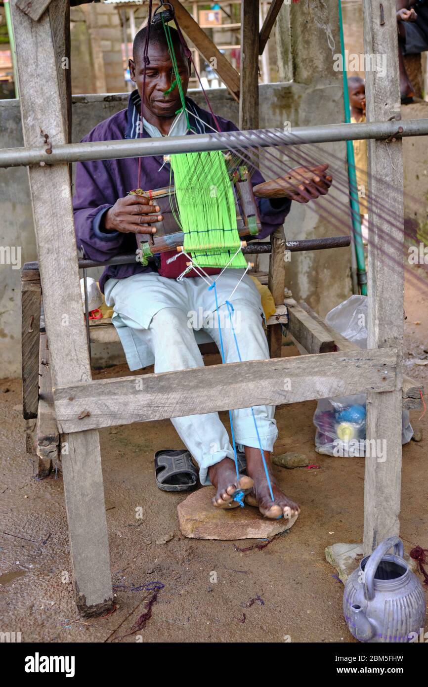 Man weaving with wool on a handmade loom Stock Photo - Alamy