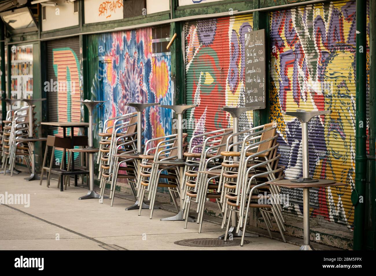 stacked chairs in front of a closed market stall Stock Photo - Alamy