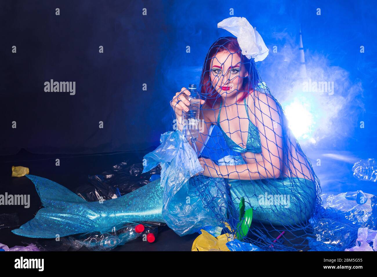 Sea plastic pollution concept. Mermaid in the ocean. Plastic is ...