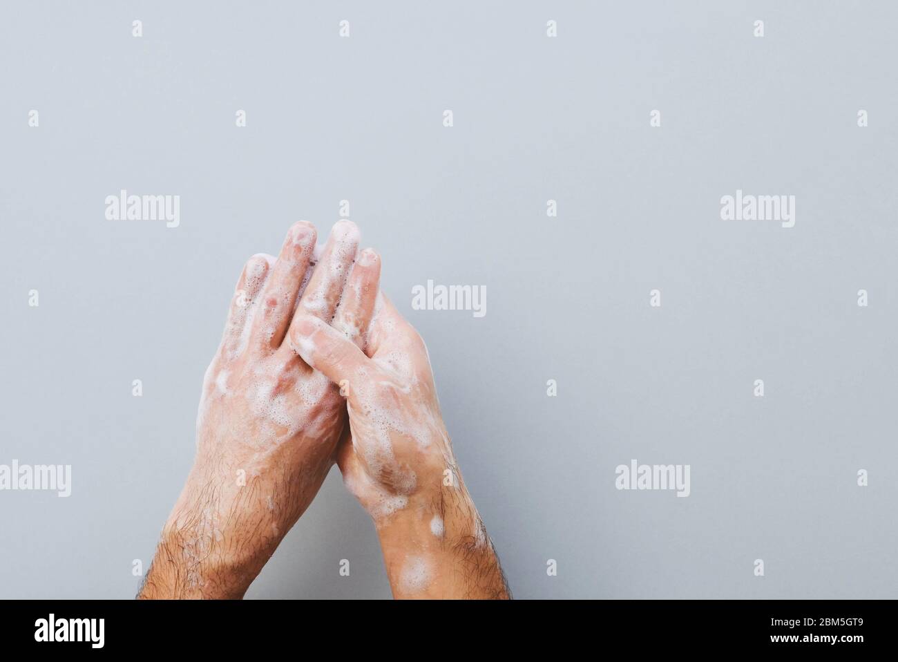 Man cleaning his hands using liquid disinfectant soap Stock Photo - Alamy