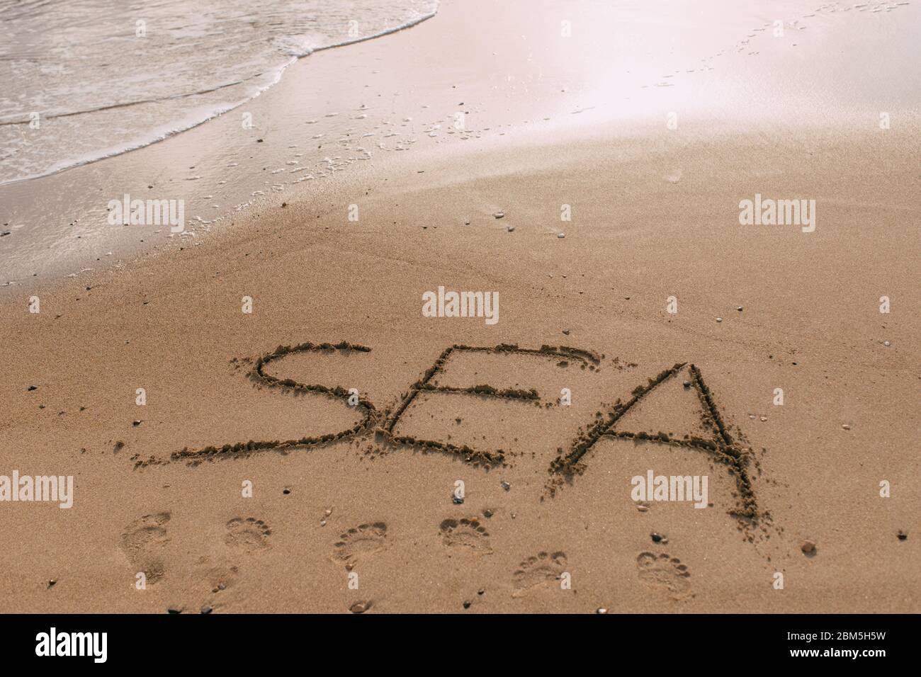 summer beach with sea lettering on sand Stock Photo - Alamy
