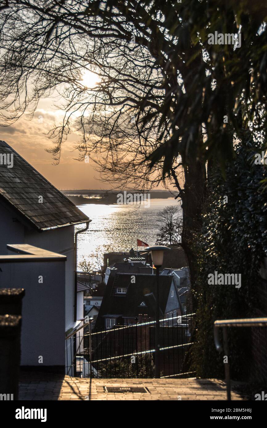 sunset view in a small town over the river Stock Photo - Alamy