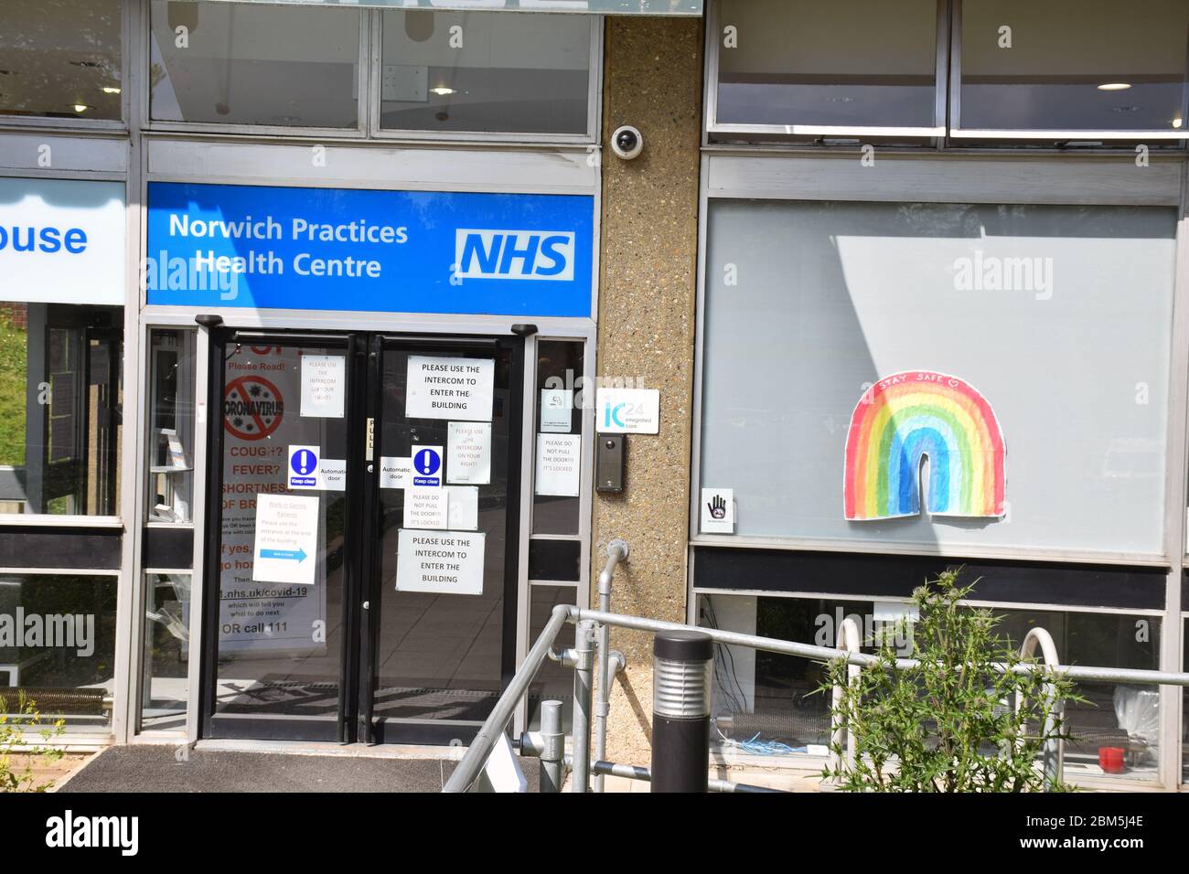 Health Centre with warning signs and rainbow drawing during Coronavirus ...