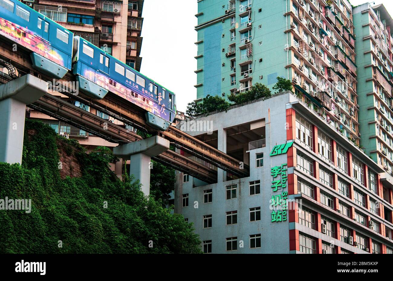 Chongqing, China - July 23, 2019: Metro train entering residential ...