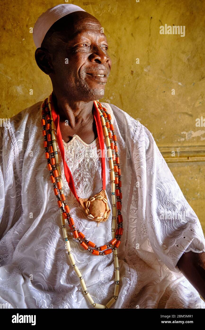 Portrait of a Yoruba priest with traditional amulets, robes and ...