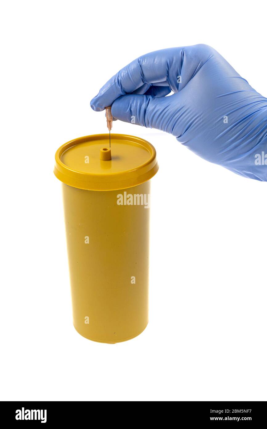 Health worker throws sharp waste into the medical waste bin. Medical ...