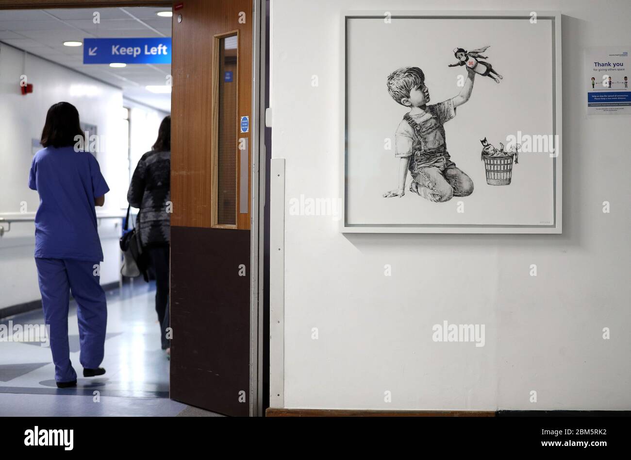A person walks past the new artwork painted by Banksy during lockdown ...