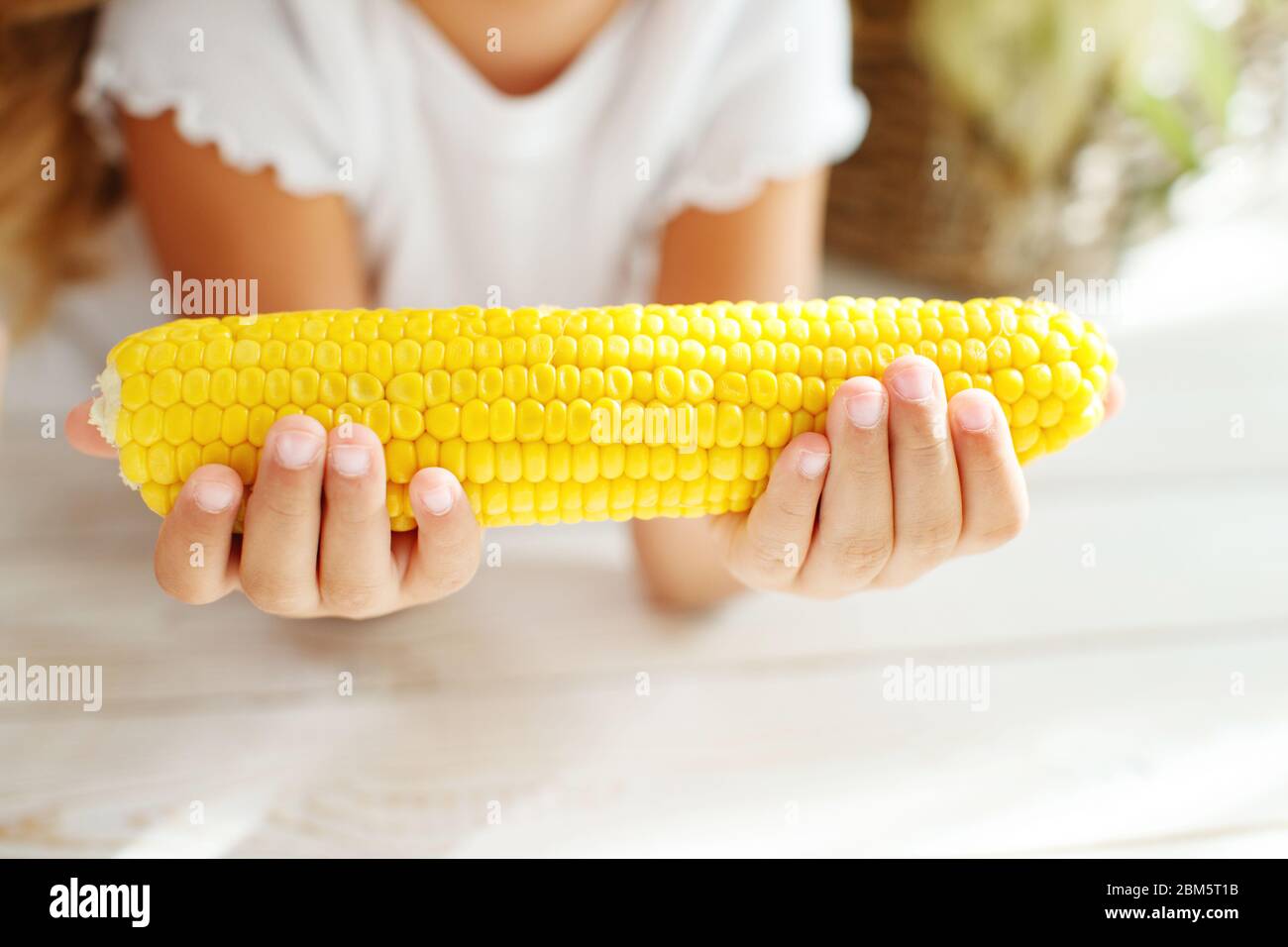 Child girl with corn in the studio Stock Photo - Alamy