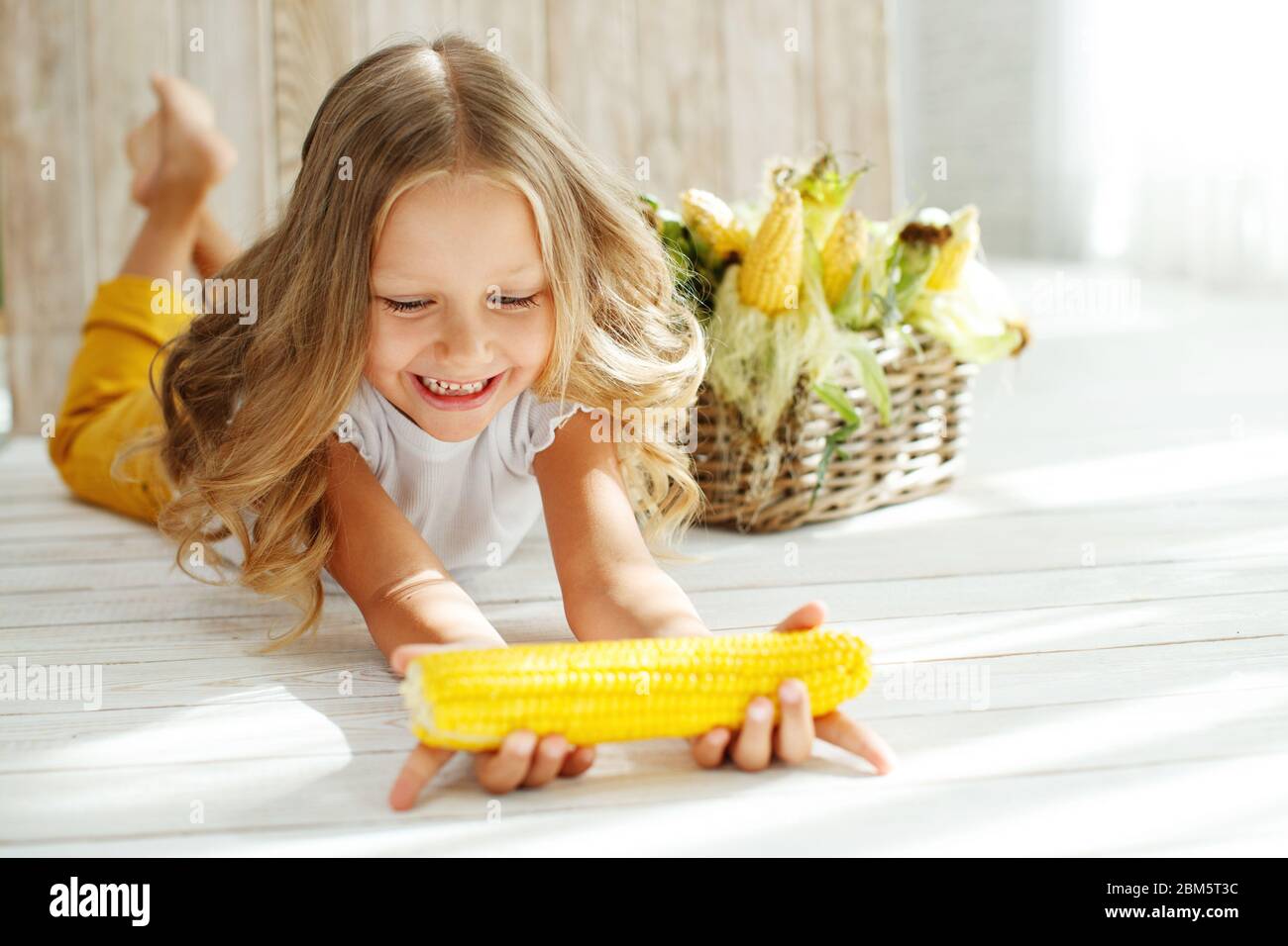 Child girl with corn in the studio Stock Photo - Alamy