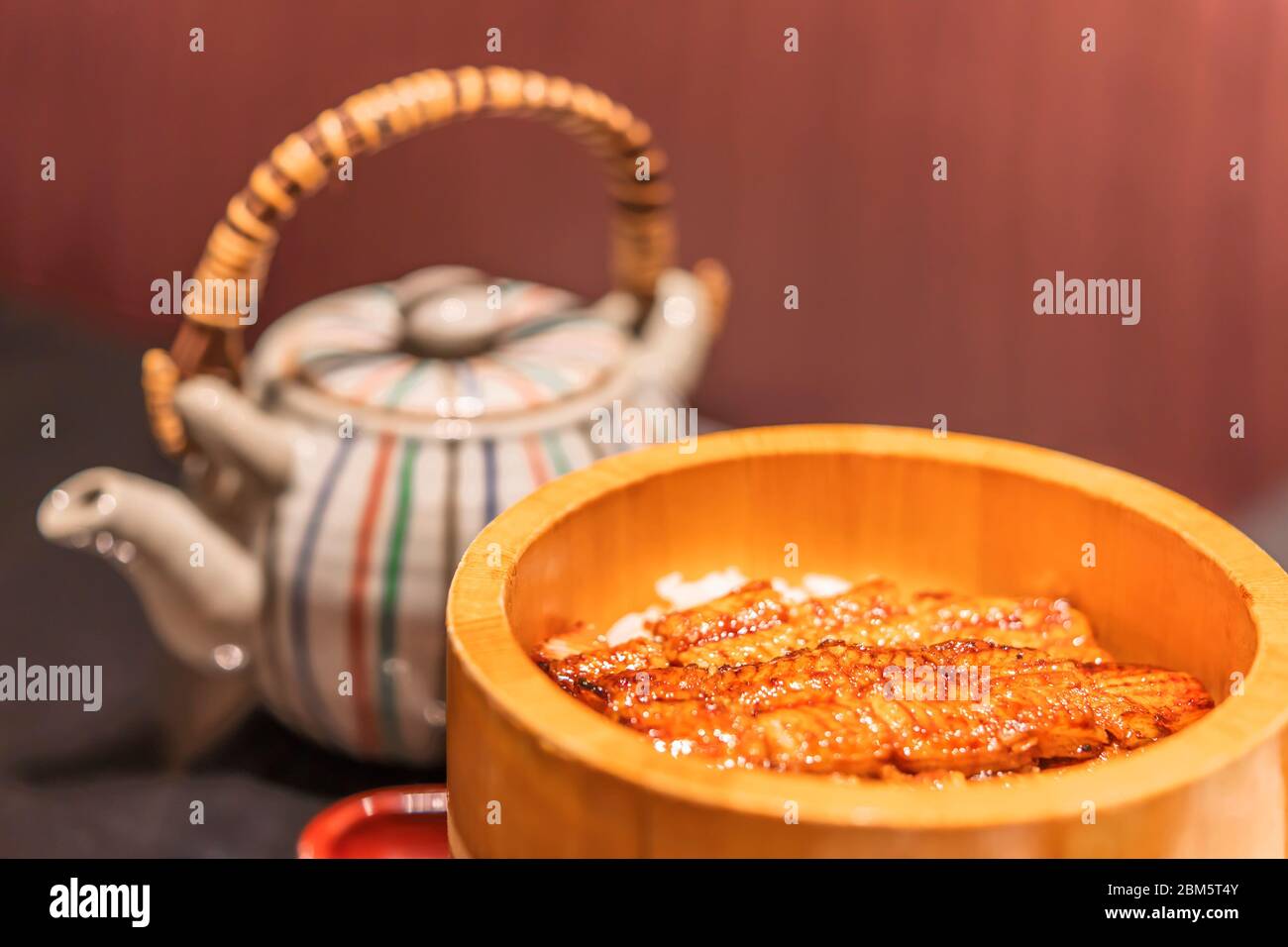 Fillets of japanese unagi eel grilled in a kabayaki style in a wooden ...
