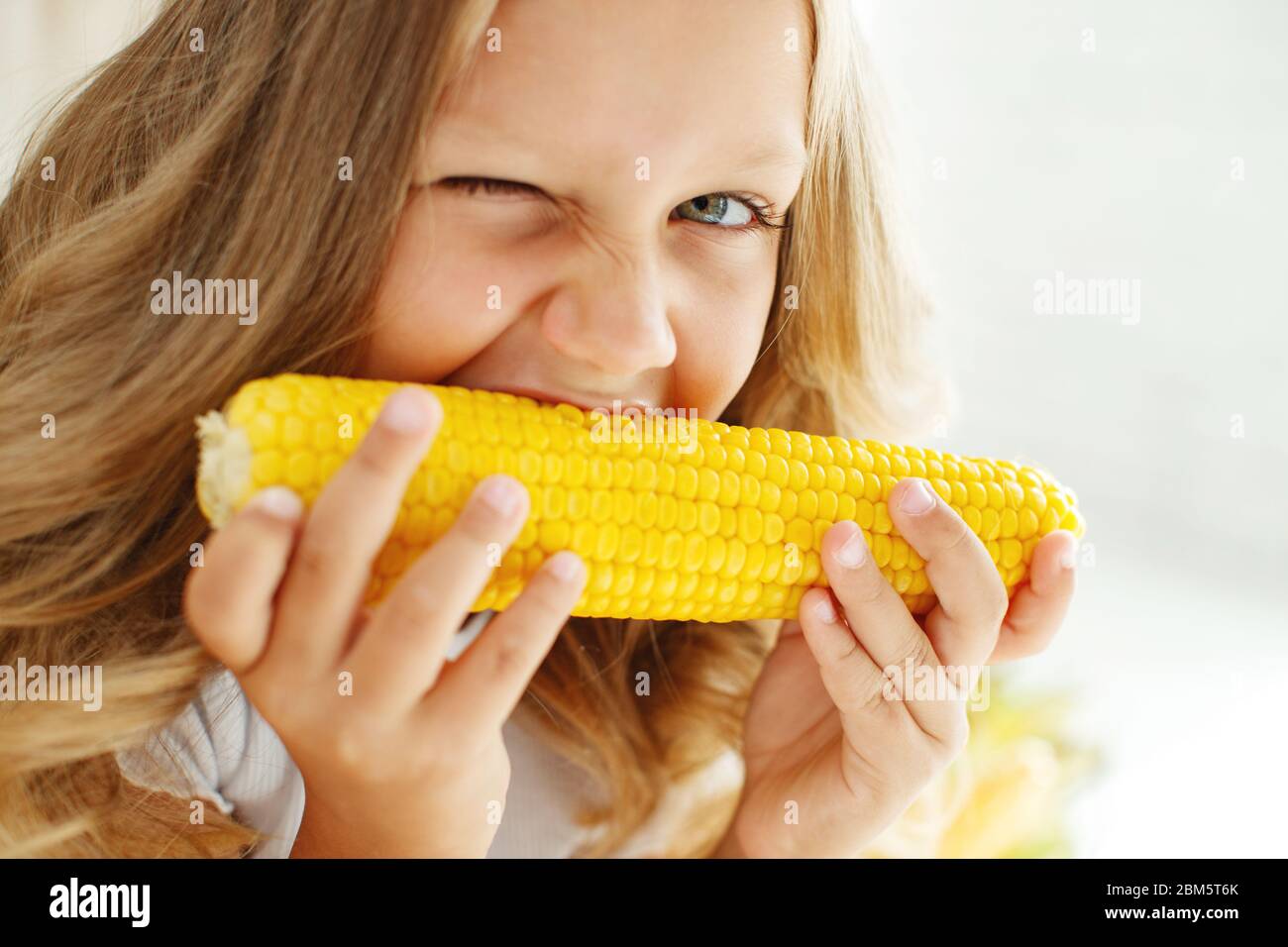 Child girl with corn in the studio Stock Photo - Alamy