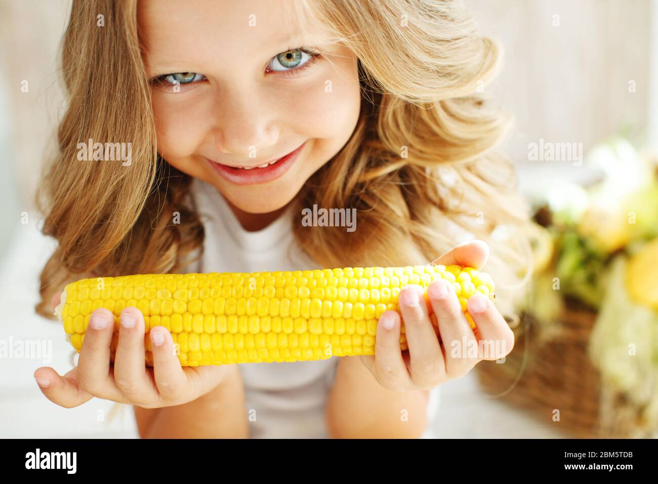 Child girl with corn in the studio Stock Photo - Alamy